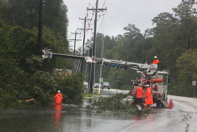 Boosting power grid resilience with pre-storm community planning and ...